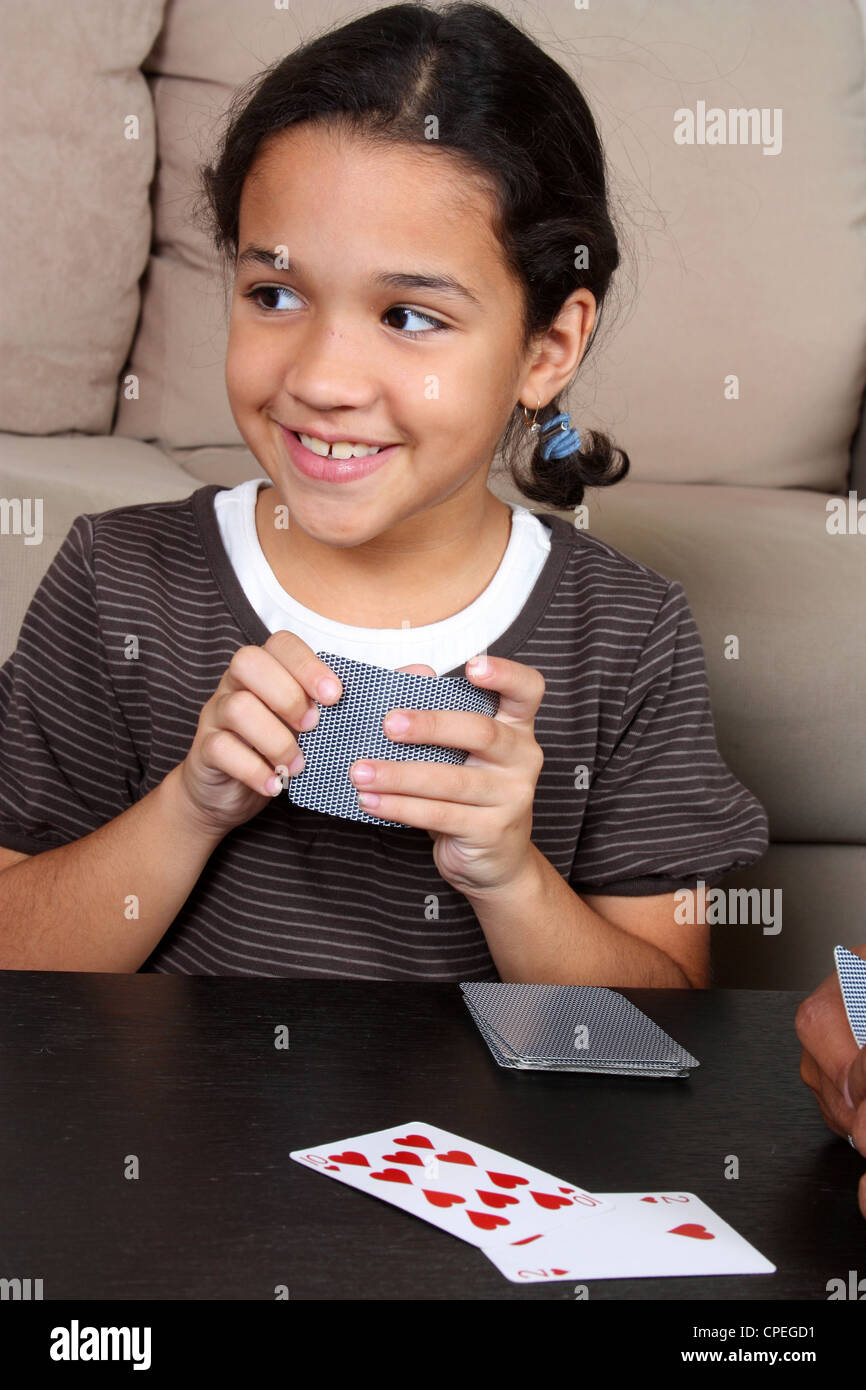 Family playing cards together around the table Stock Photo - Alamy