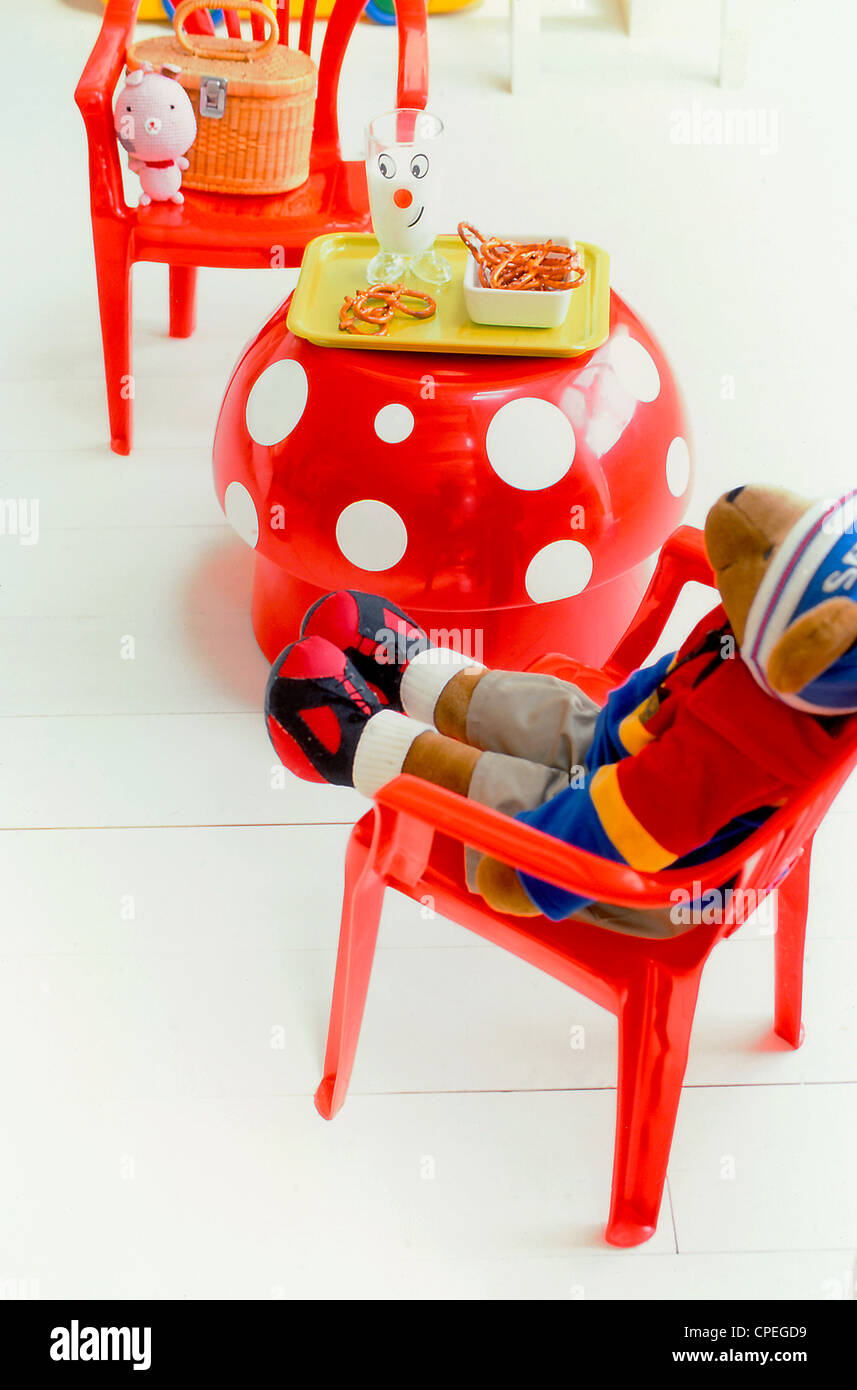 Teddy On Red Chair Stock Photo - Alamy