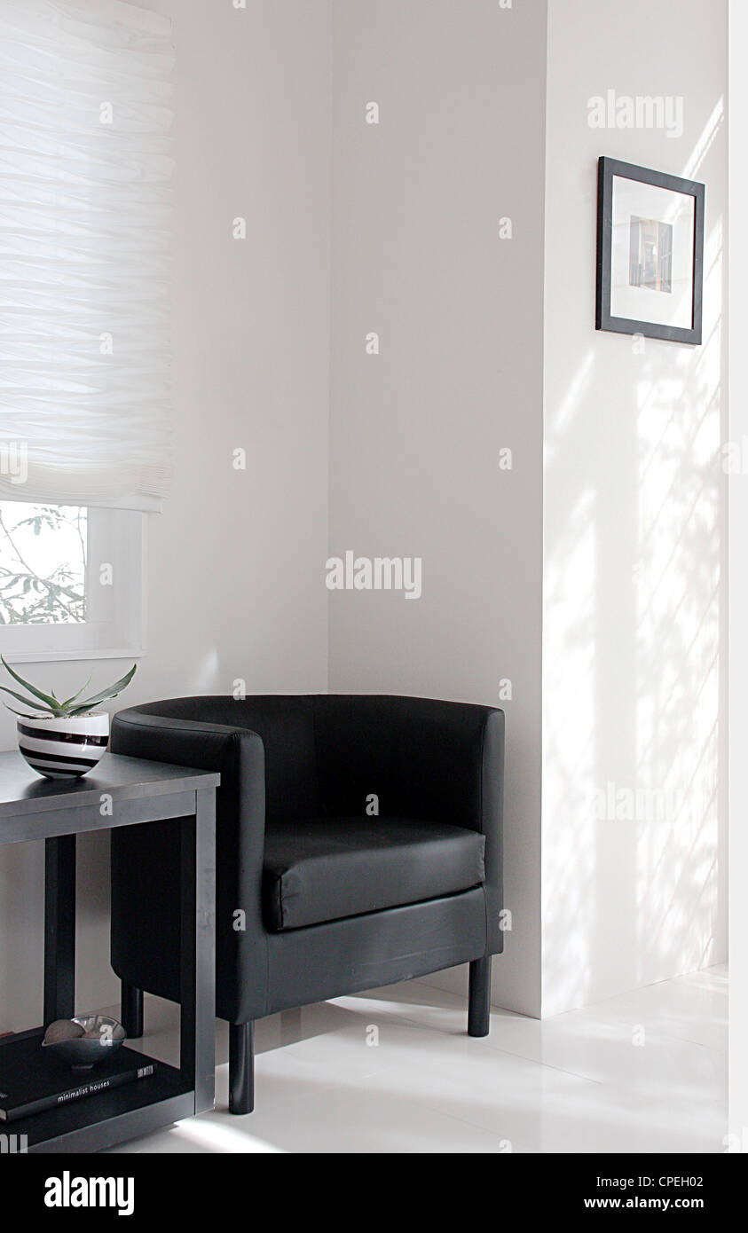 Stylish Easy Chair And Side Table Near Window Stock Photo - Alamy