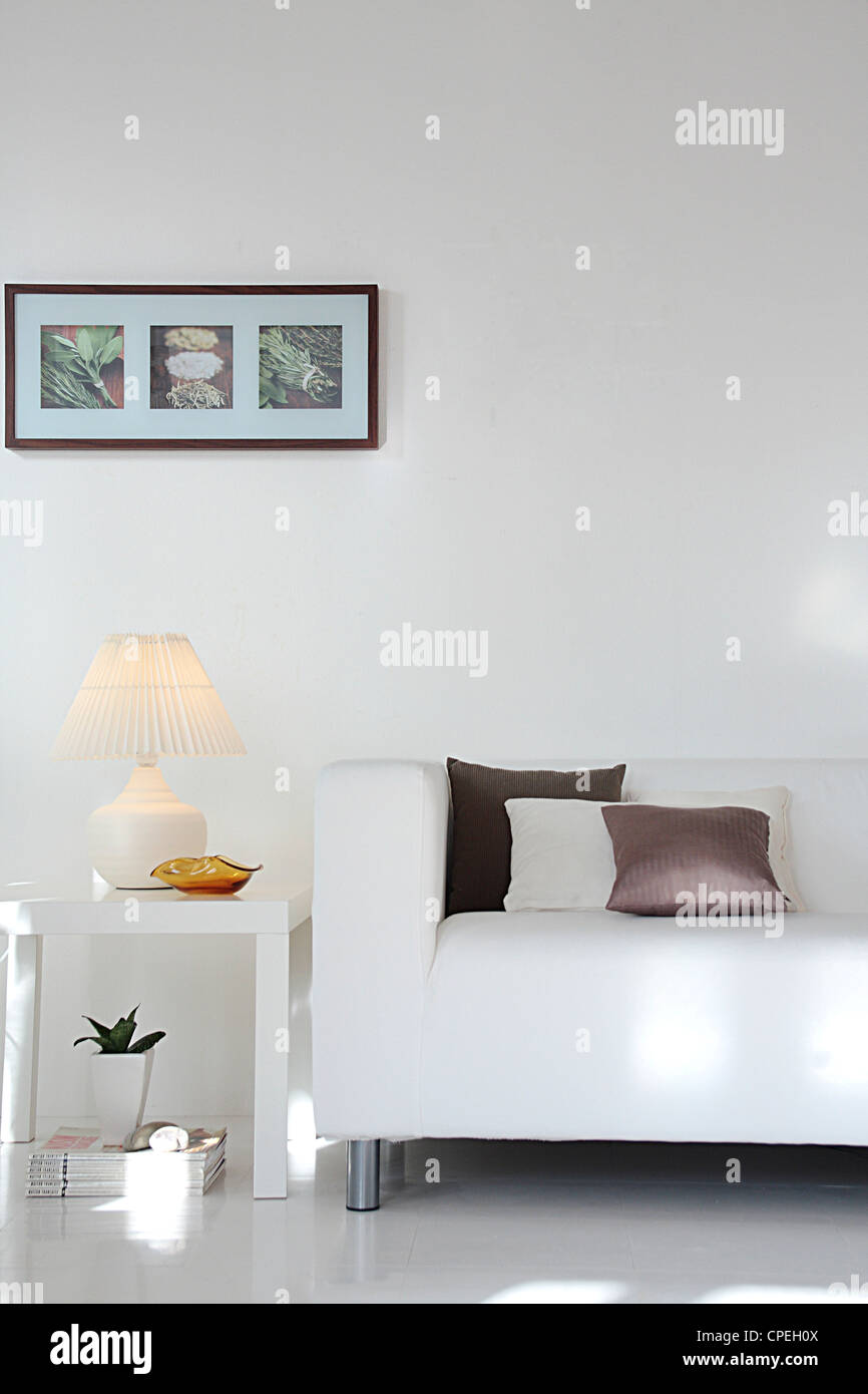 Cushions On Sofa And Side Table With Lamp Stock Photo - Alamy
