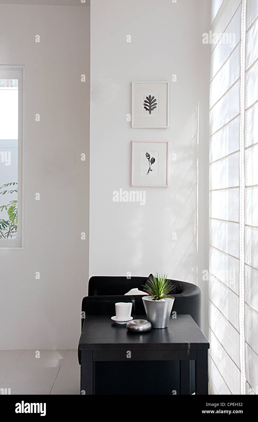 Stylish Easy Chair And Side Table Near Window Stock Photo - Alamy