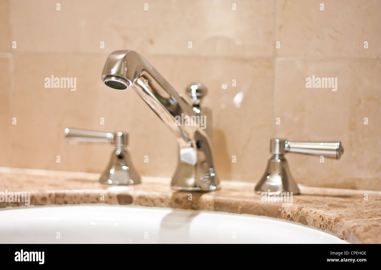 Tap in an Italian luxury hotel, steel on marble Stock Photo - Alamy