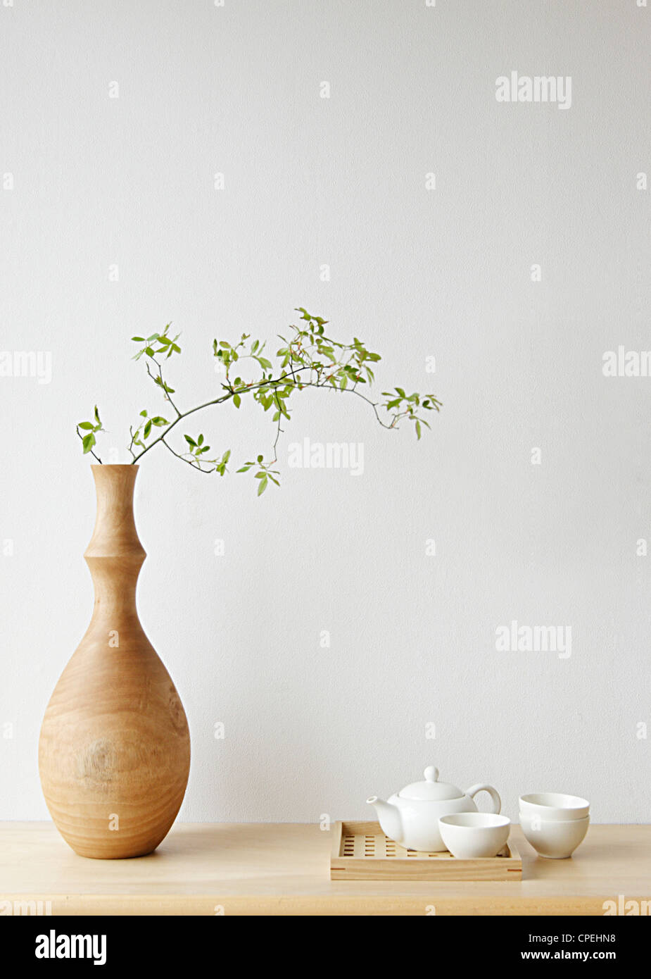 Tea Set Beside Plant In Vase Stock Photo - Alamy