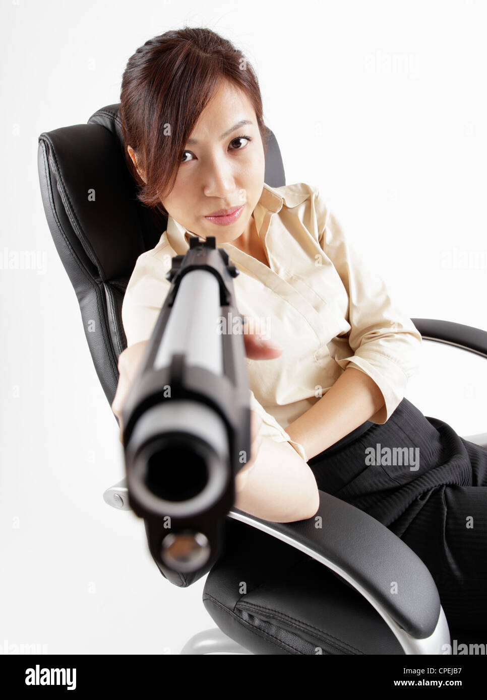 Office lady shoots gun by sitting on chair Stock Photo - Alamy