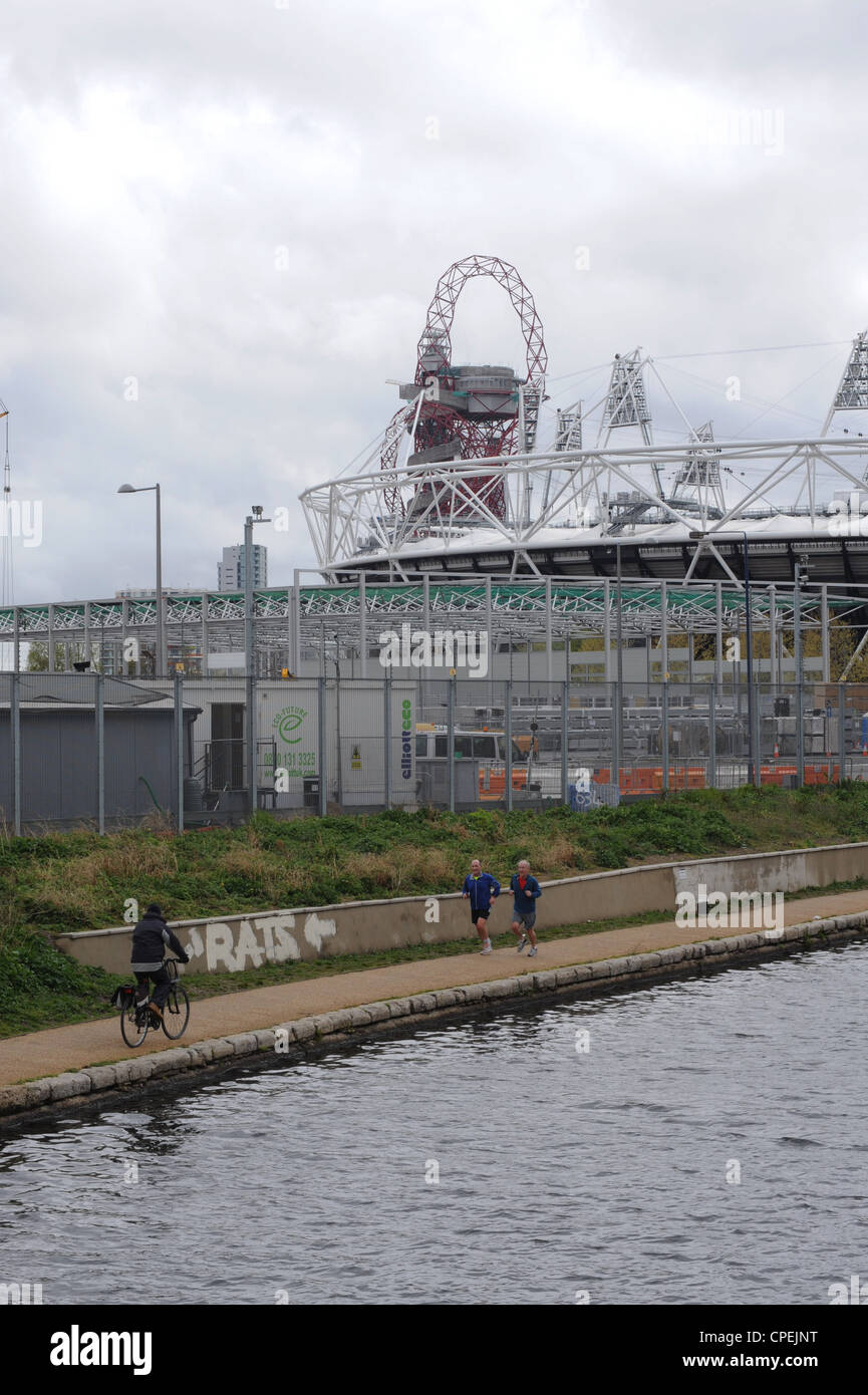 Cyclist and runners along the canal at Hackney wick with excellent view ...