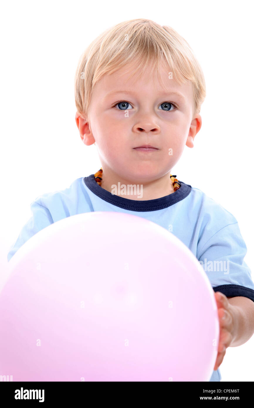 Young boy holding ball Stock Photo - Alamy