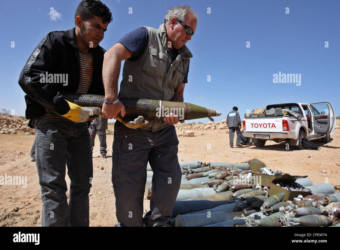International bomb disposal member and local employee prepare ...