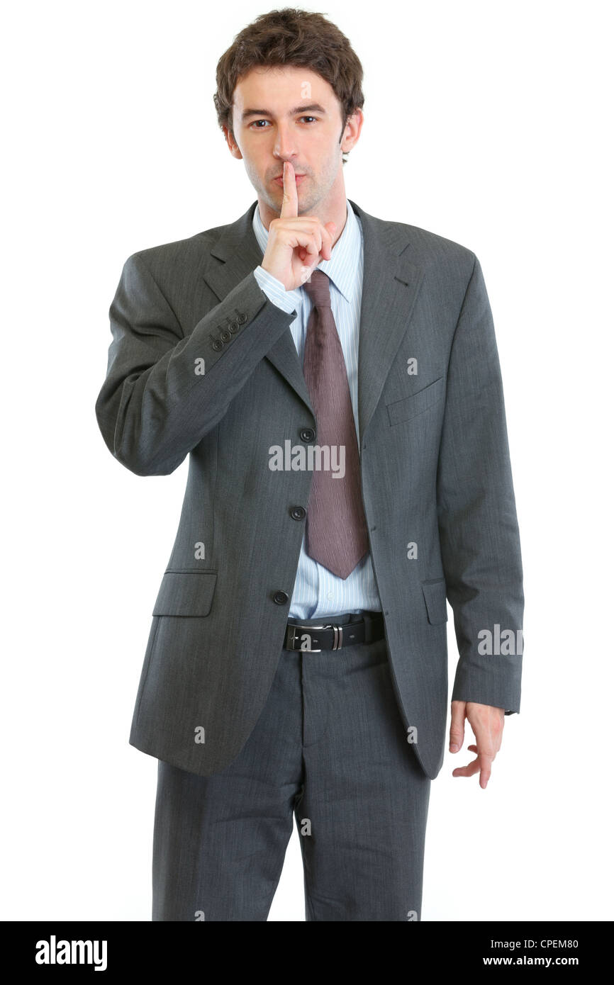 Modern businessman showing shh gesture Stock Photo - Alamy