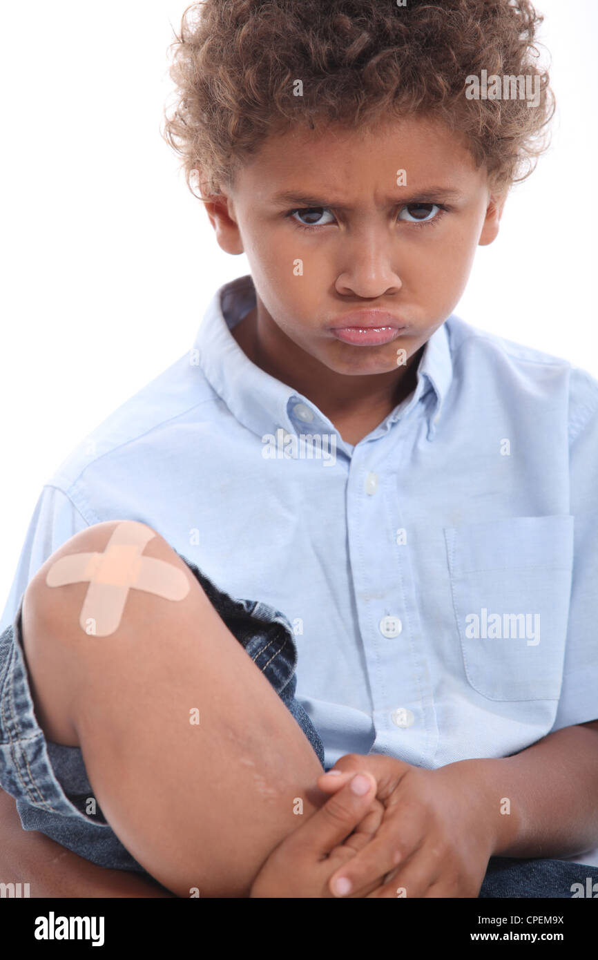 Little boy with plaster on knee Stock Photo - Alamy