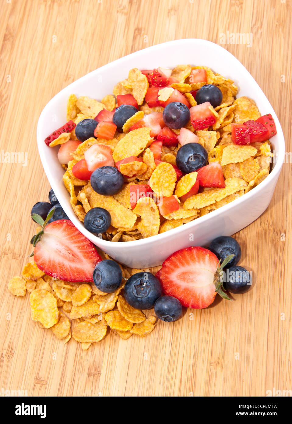 Heap of Cornflakes with fruits (Strawberries and Blueberries) in a bowl ...