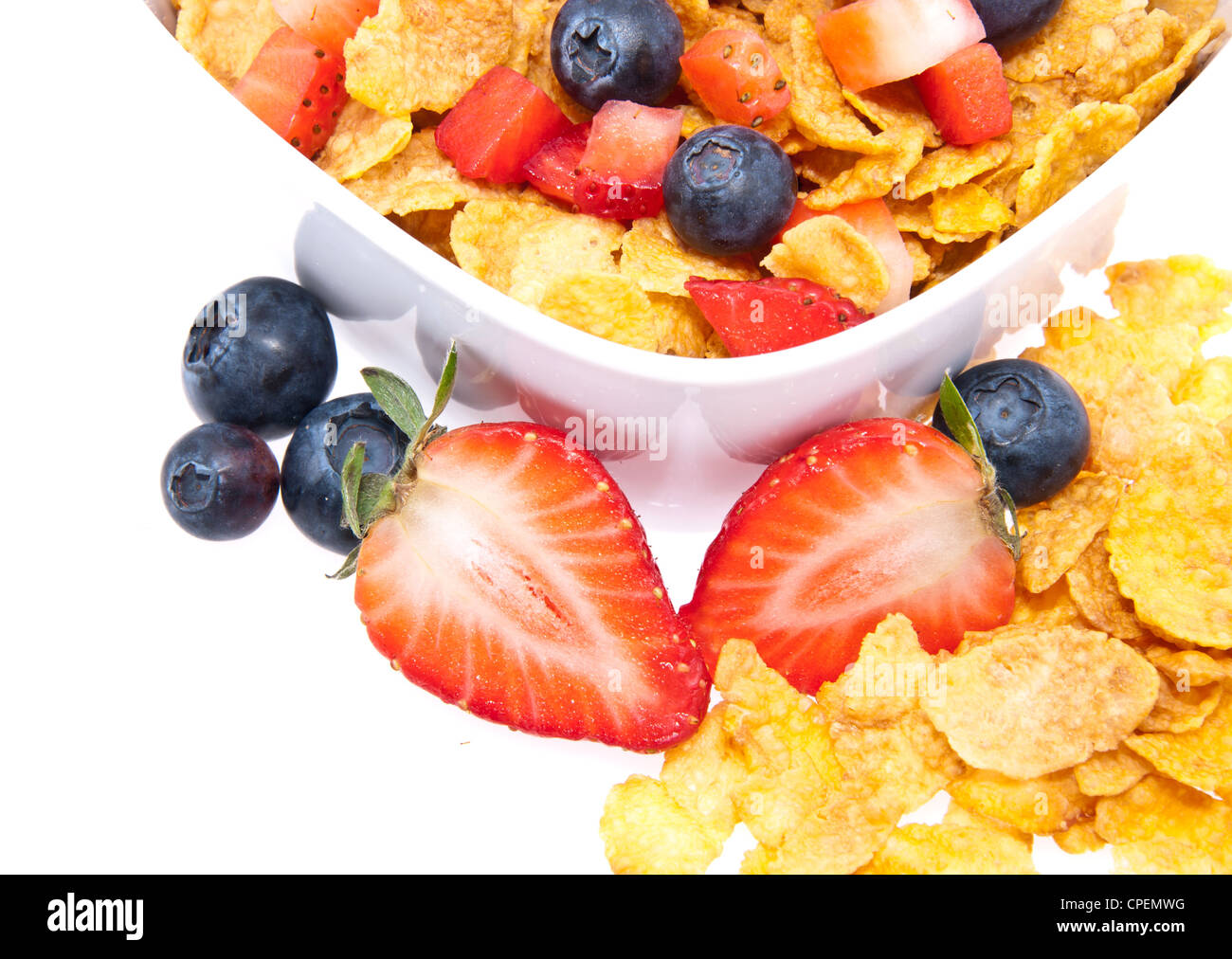 Cornflakes with fresh fruits in a bowl isolated on white background ...