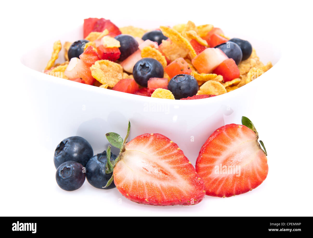 Cornflakes with fresh fruits in a bowl isolated on white background ...
