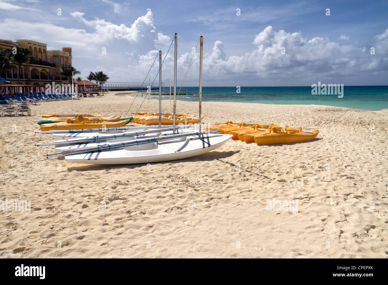 A group of personal sail boats on the beach by the ocean Stock Photo ...
