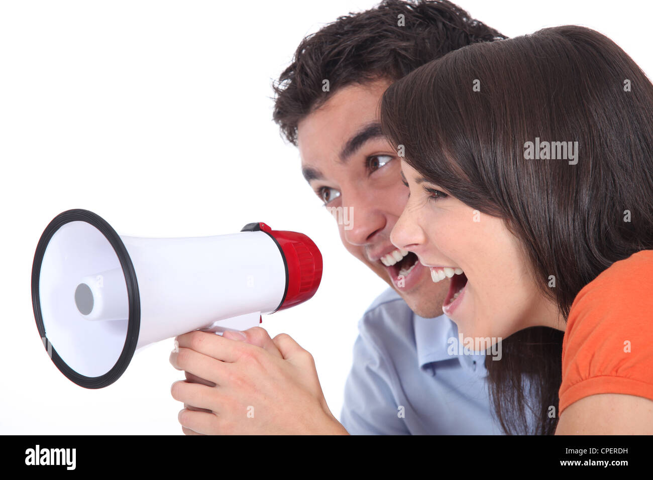 Young couple shouting into a megaphone Stock Photo - Alamy