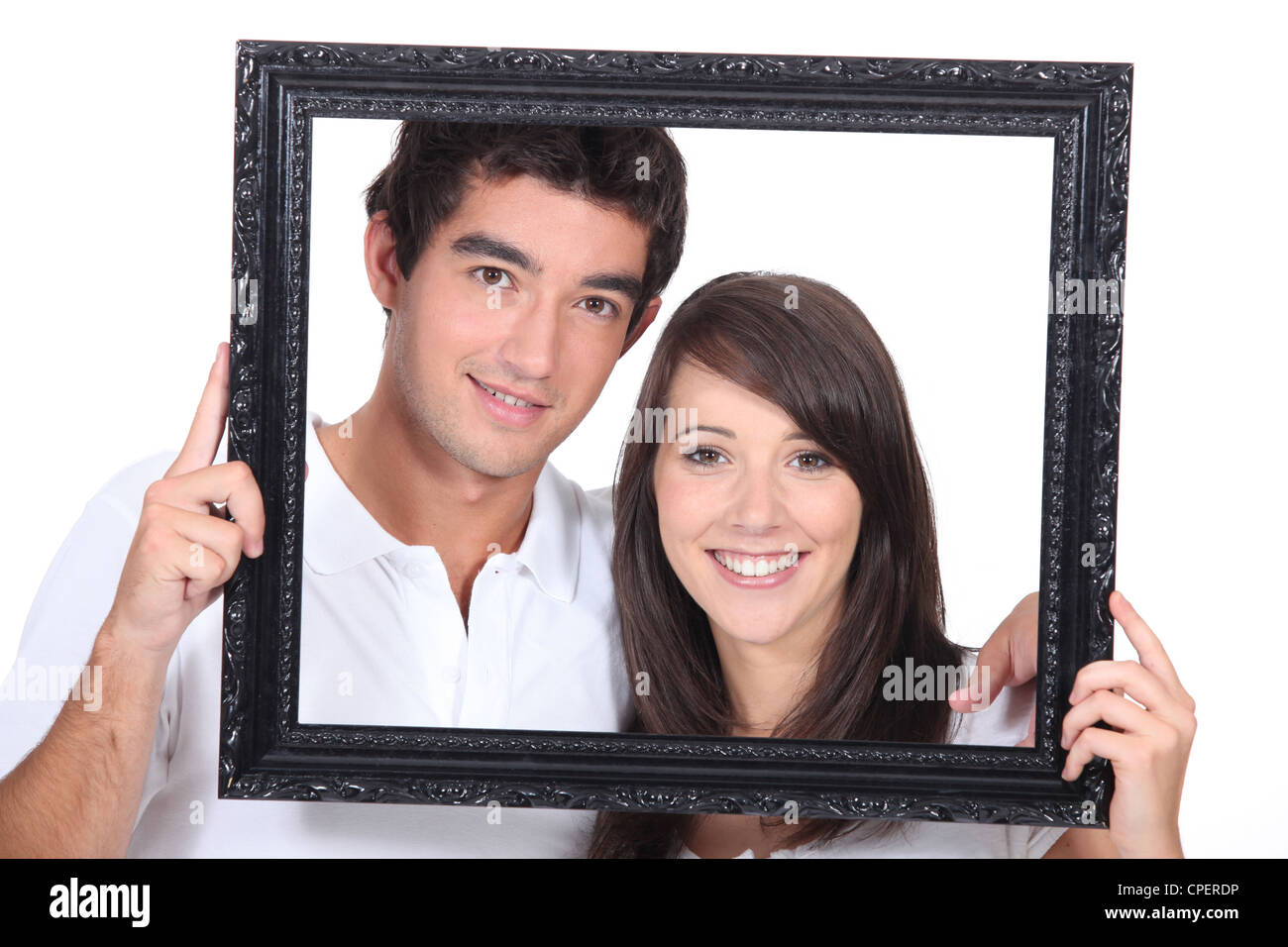 Teenagers holding photo frame Stock Photo - Alamy