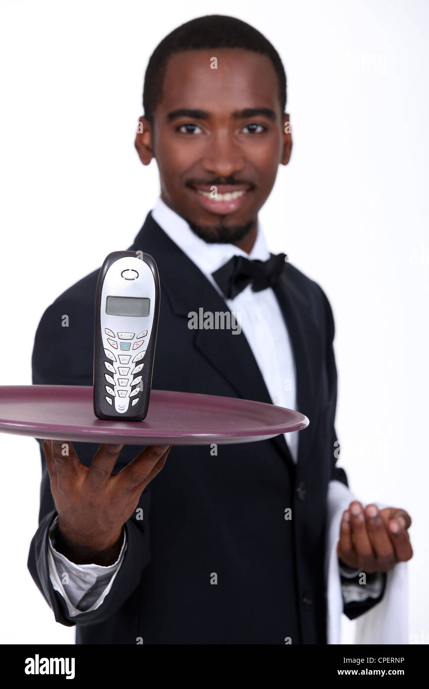 Waiter with a cellphone on a tray Stock Photo - Alamy