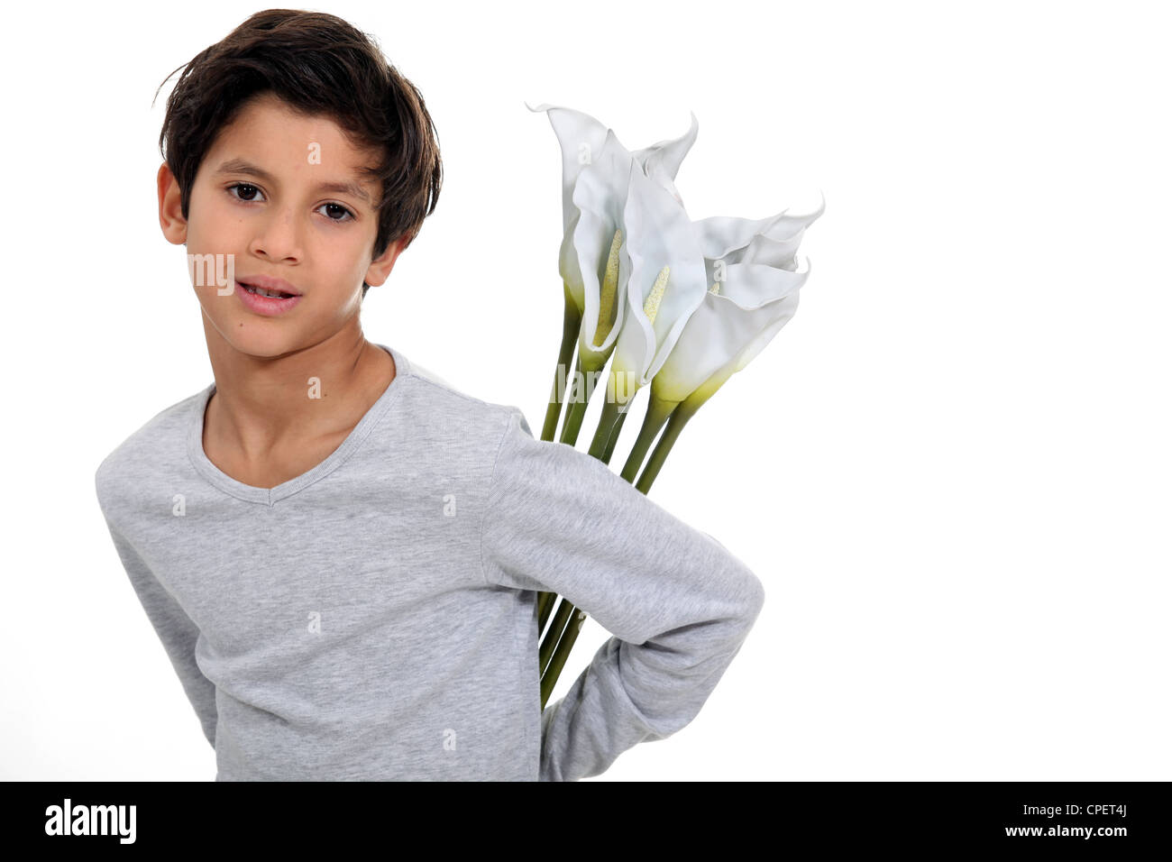Boy holding flowers behind his back hi-res stock photography and images ...