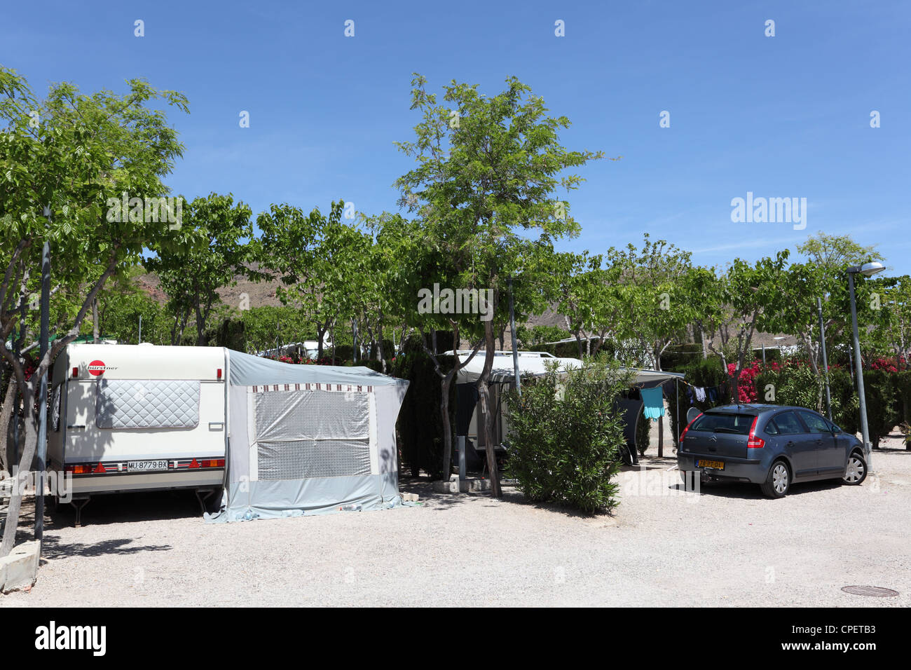 Caravan and car on a camping site in Spain Stock Photo - Alamy