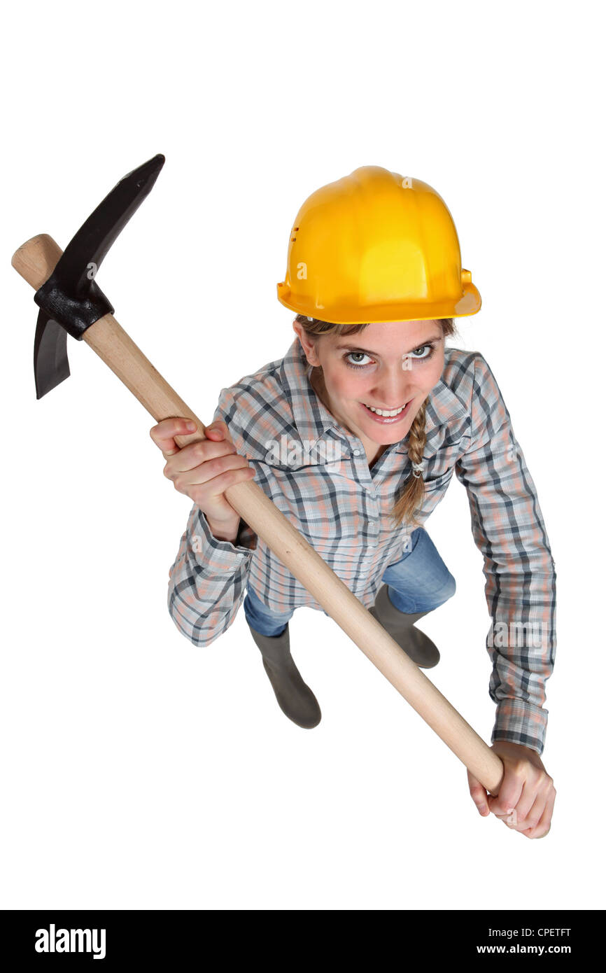 Woman with a helmet holding a pickaxe Stock Photo - Alamy