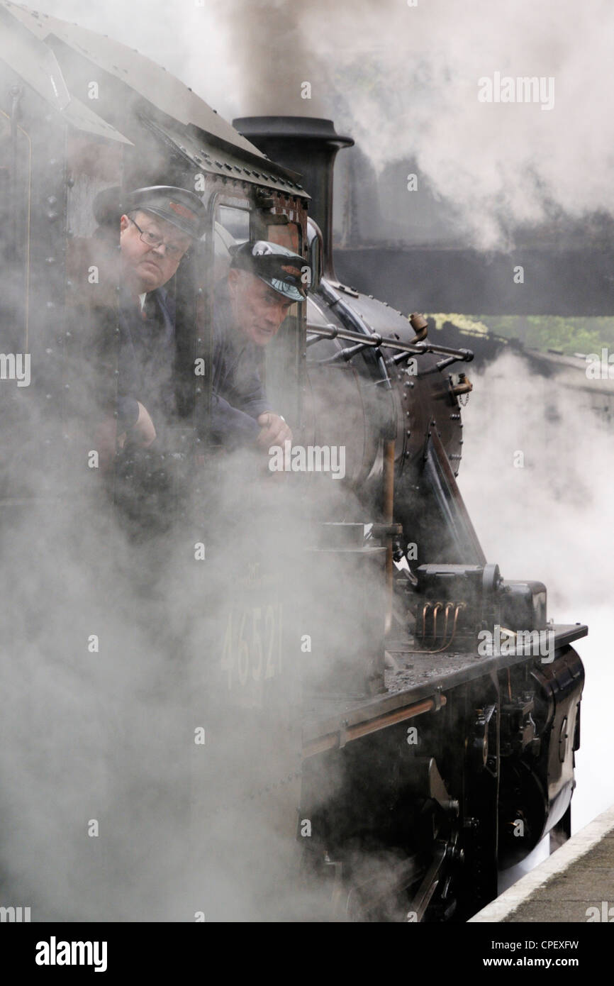 Steam train driver looking back waiting permission to leave with his ...