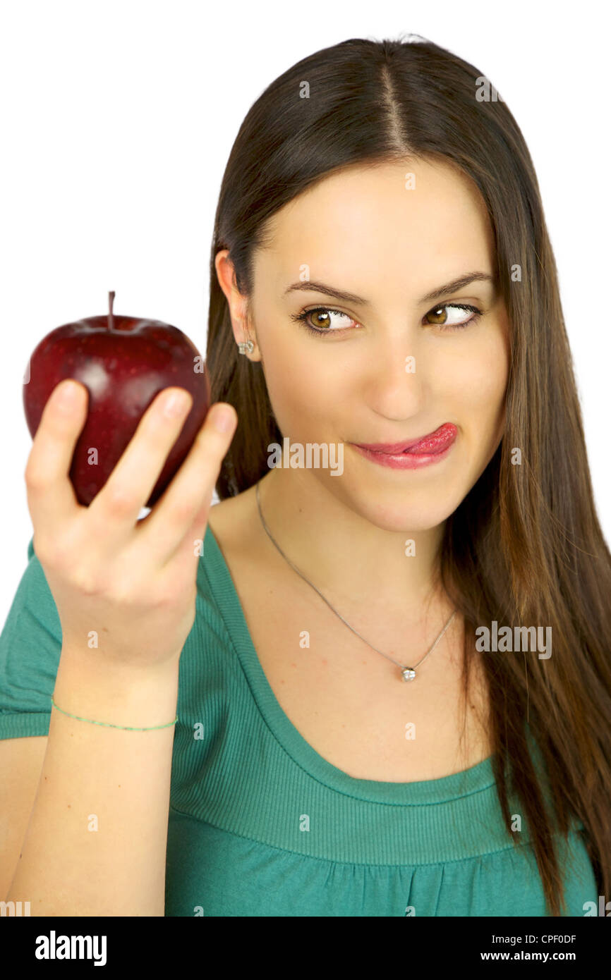 Young female model observing intense a big red apple ready to eat it ...