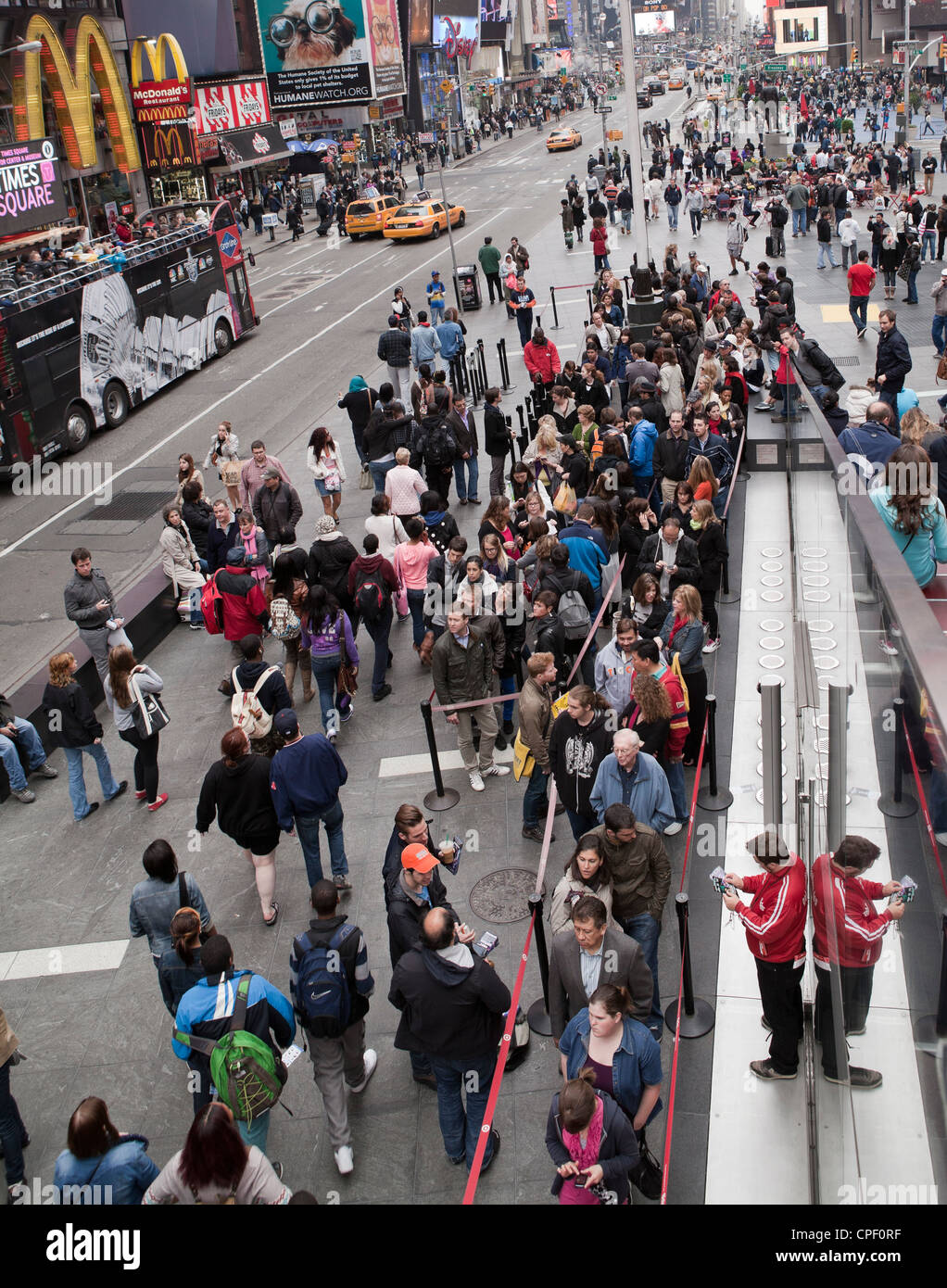 People line up for discount theater tickets in Times Square in New York ...