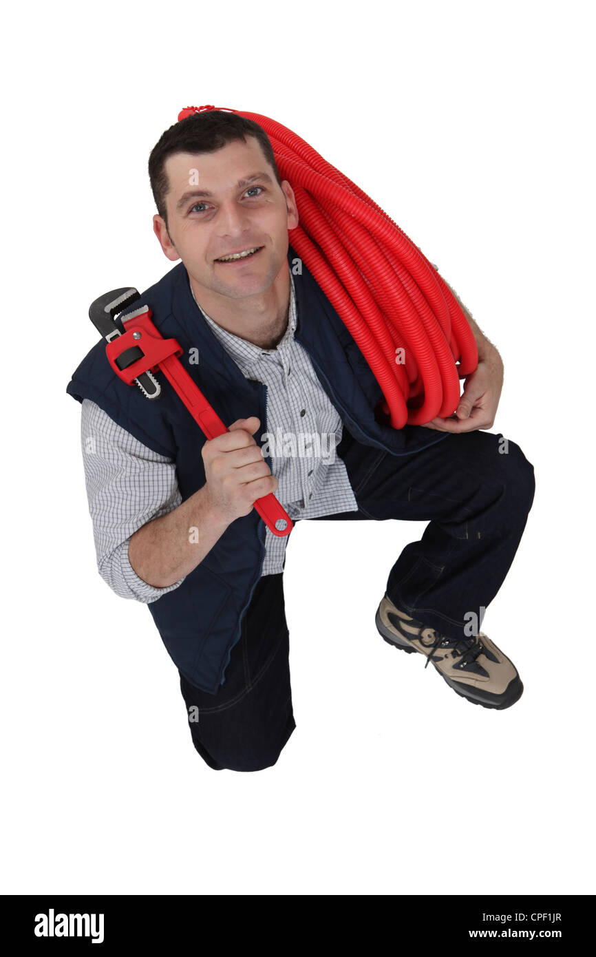 A kneeled plumber Stock Photo - Alamy