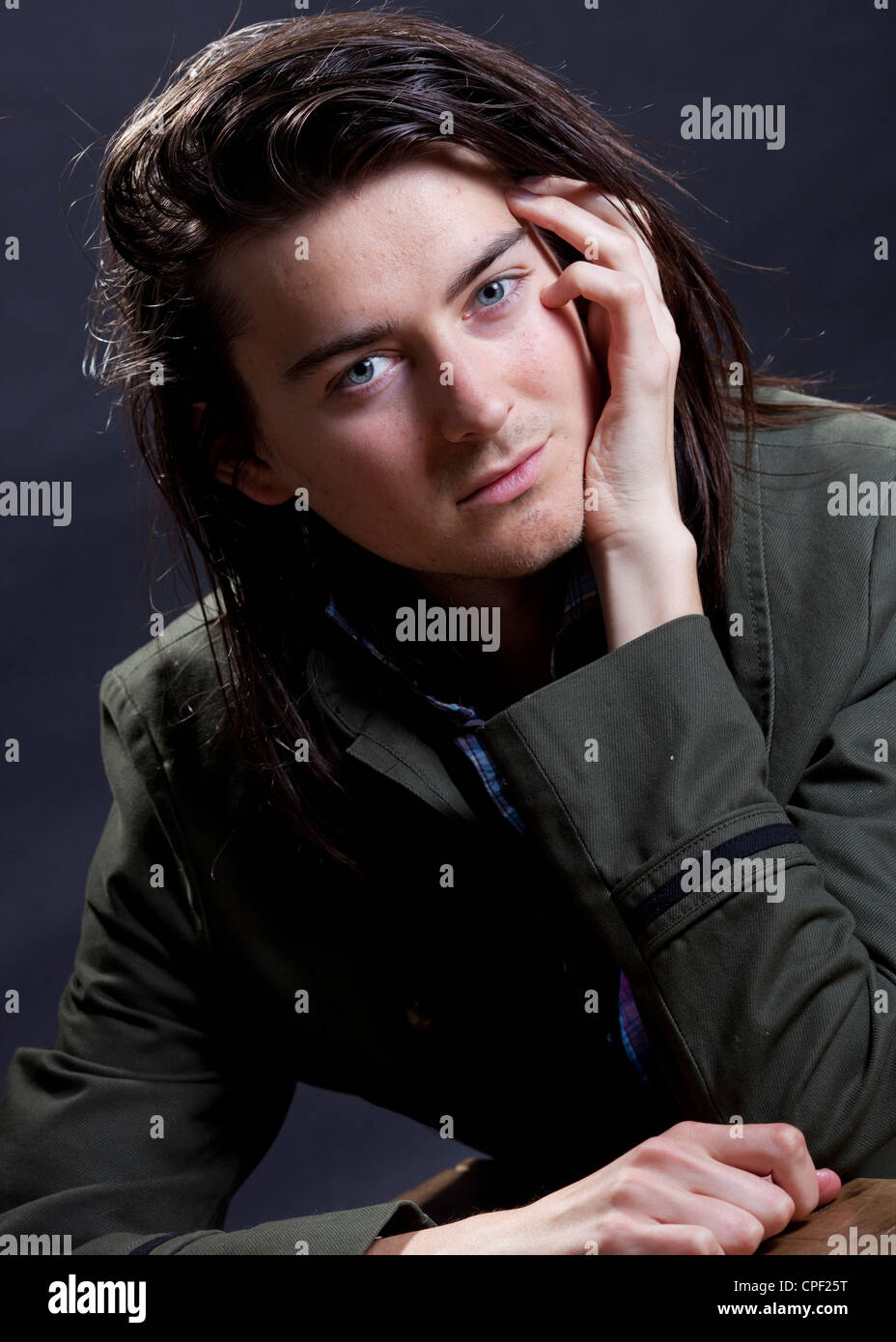 Head and shoulders colour photograph of male model photographed against ...