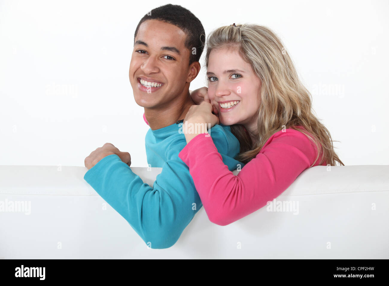 Couple relaxing together on sofa Stock Photo - Alamy