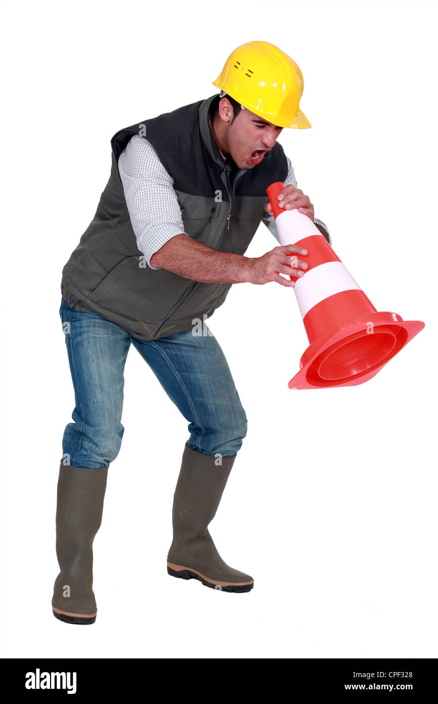Frustrated builder shouting into traffic cone Stock Photo - Alamy