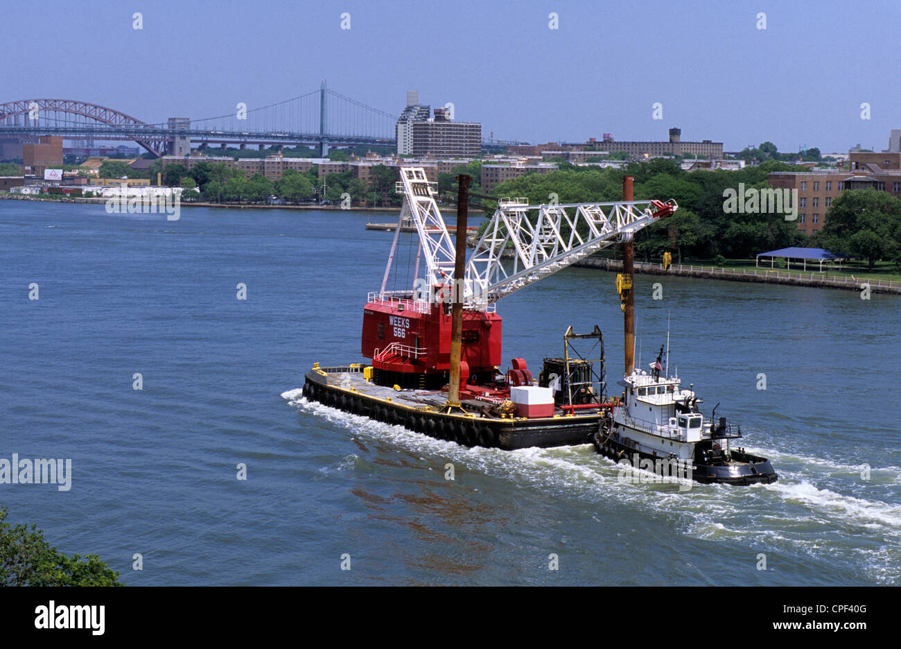 Tugboat pushing barge, scow, floating platform, construction crane East ...
