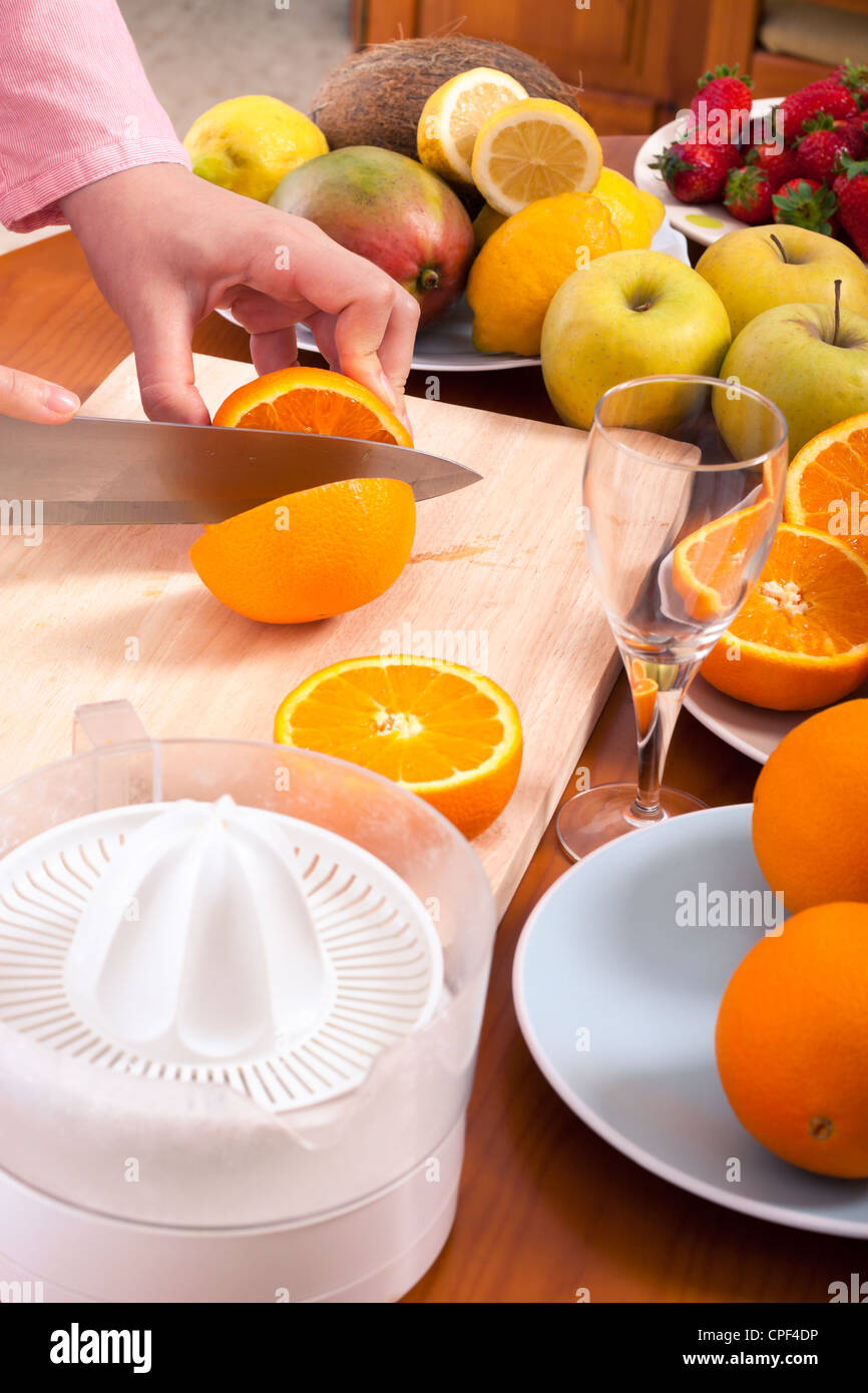 Detail of hand cutting oranges and preparing fresh homemade orange ...