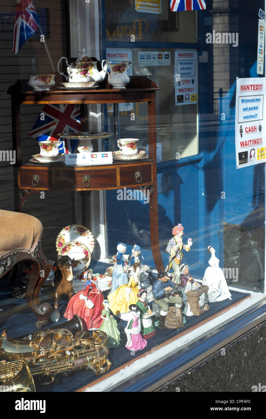 Ornaments and figurines in a second hand shop window Stock Photo - Alamy