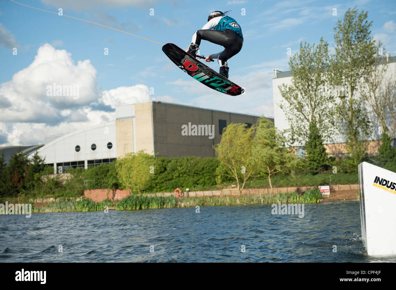 A professional wake-boarder mid-air on a new cable pulled wake-boarding ...