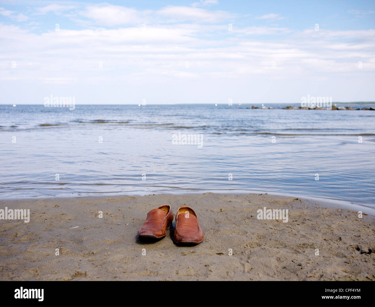A pair of shoes standing at the beach Stock Photo - Alamy