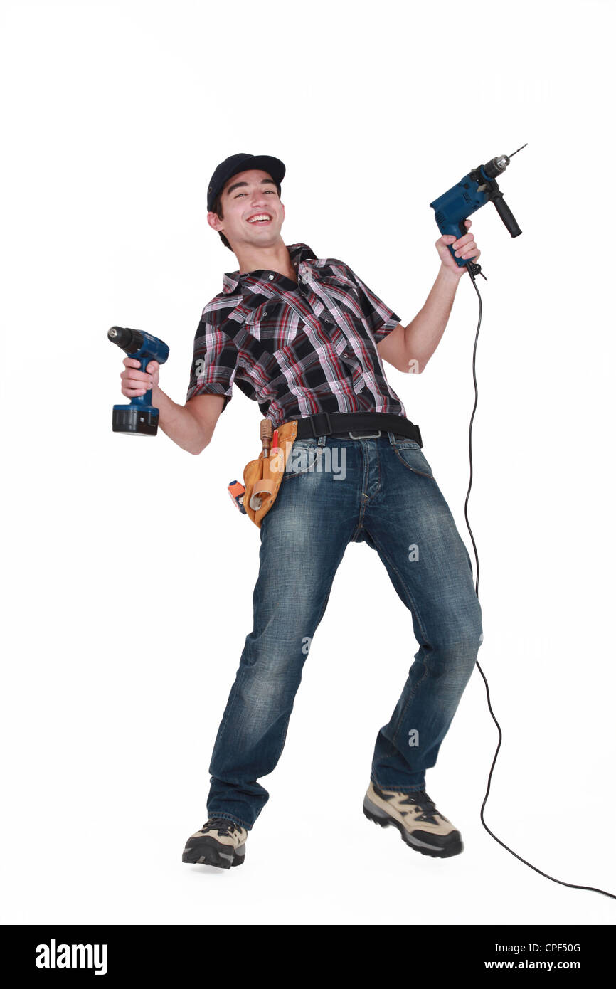 A tradesman holding power tools Stock Photo - Alamy