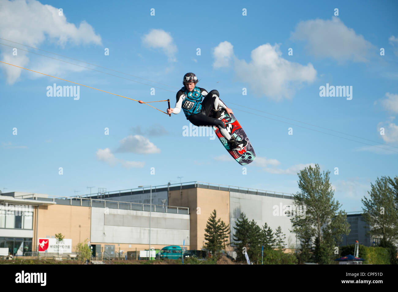 A professional wake-boarder mid-air on a new cable pulled wake-boarding ...
