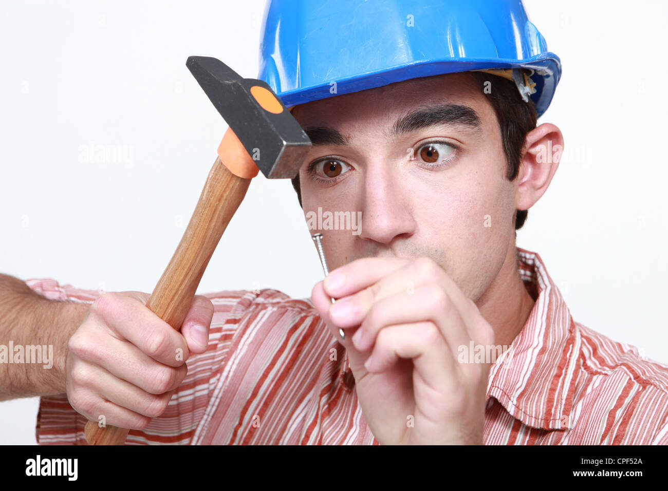 Construction worker hitting nail hi-res stock photography and images ...