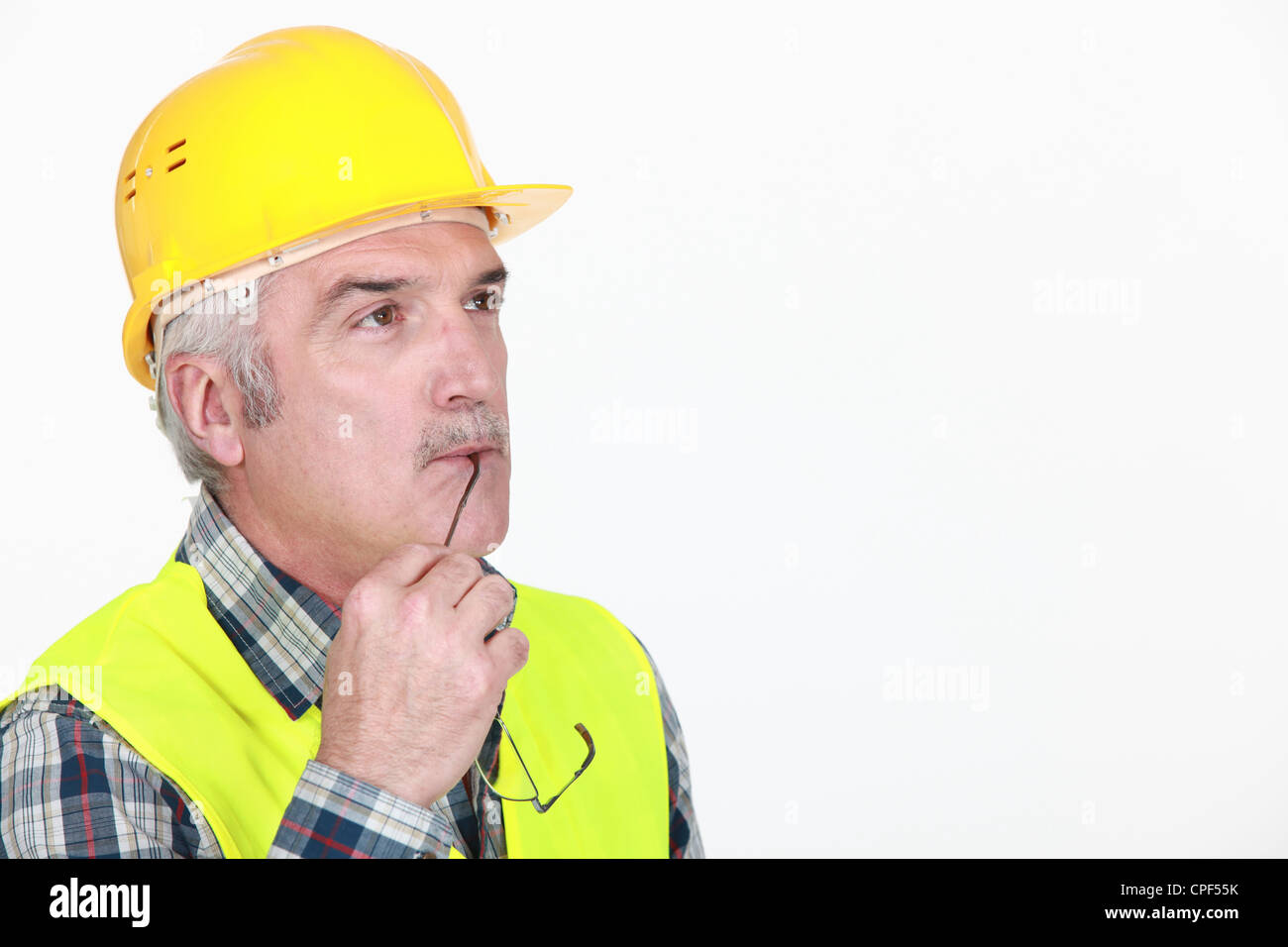 Pensive construction worker Stock Photo - Alamy