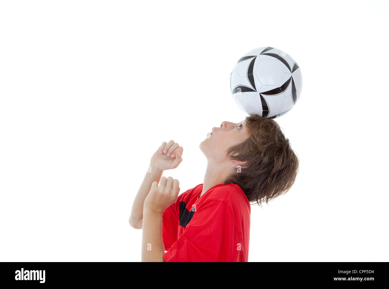 young boy soccer or football player balancing ball on head Stock Photo ...