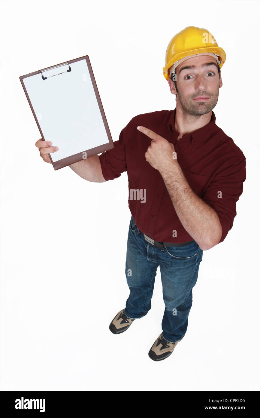 Construction worker pointing at his clipboard Stock Photo - Alamy