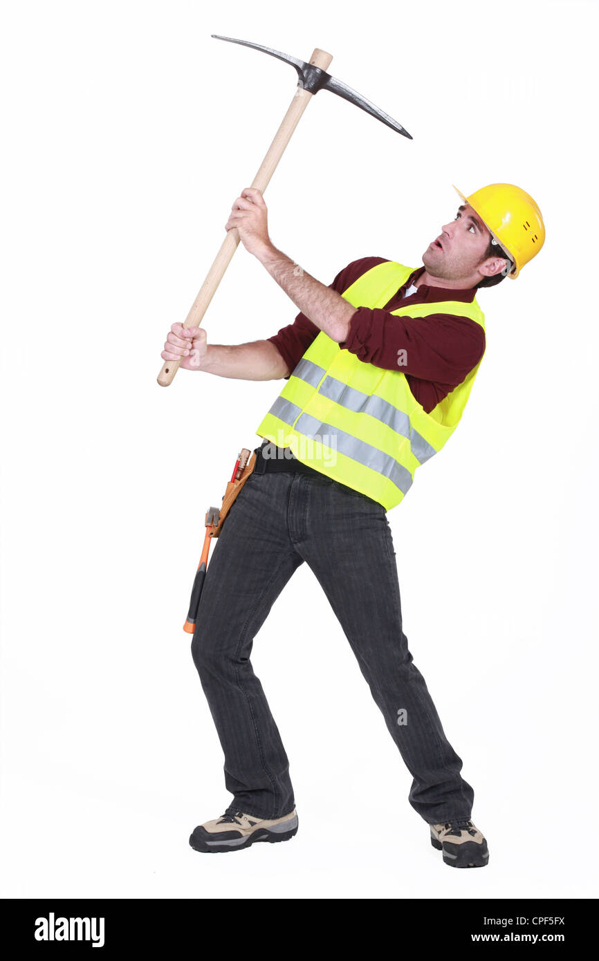 Worker with a pickaxe Stock Photo - Alamy