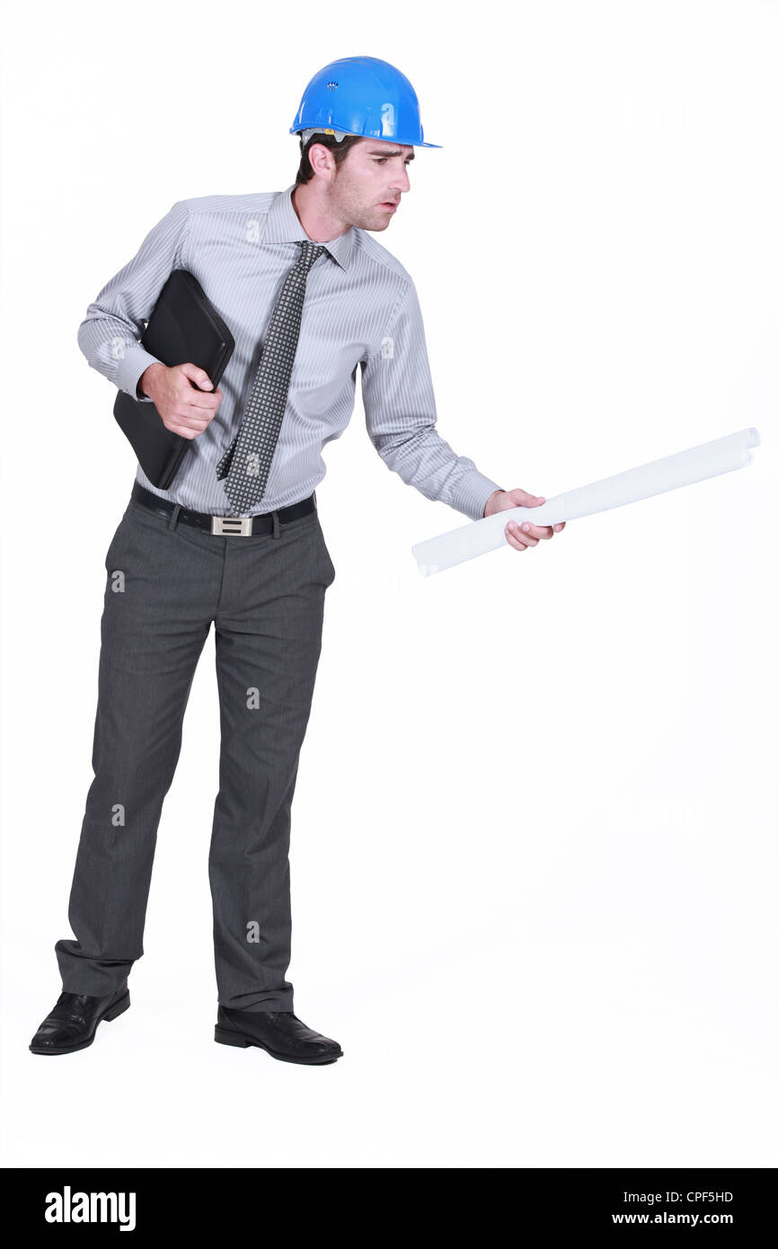 architect with briefcase holding blue prints looking concerned Stock ...