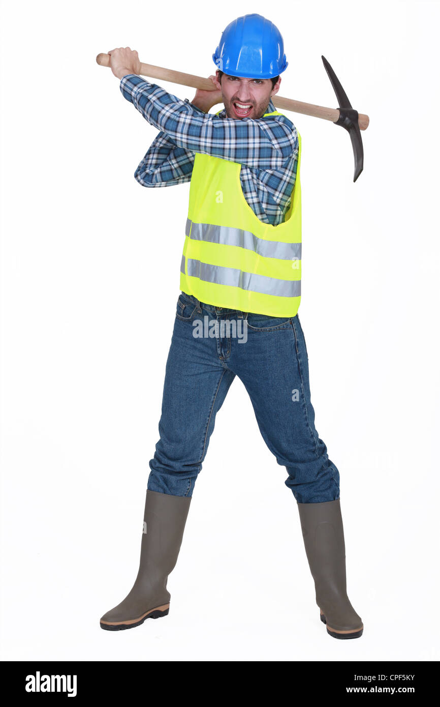 A man construction worker with a pickaxe Stock Photo - Alamy