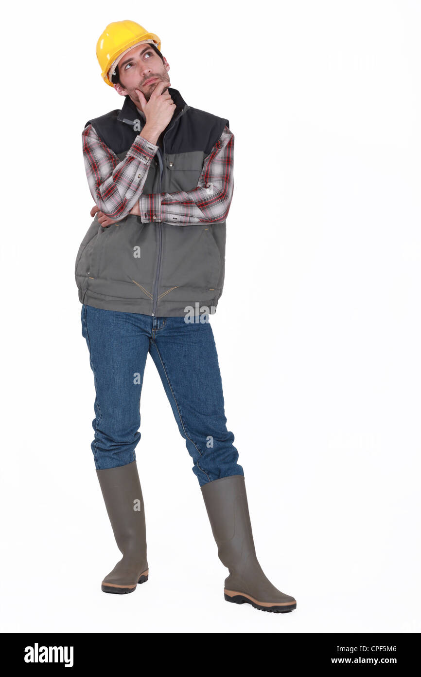 full-length portrait of craftsman looking puzzled Stock Photo - Alamy