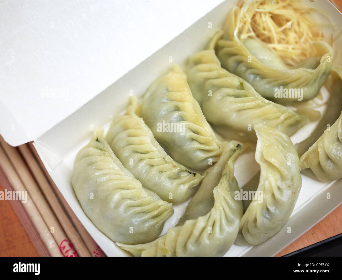 Dumplings, a traditional Chinese delicacy, being prepared by a street ...