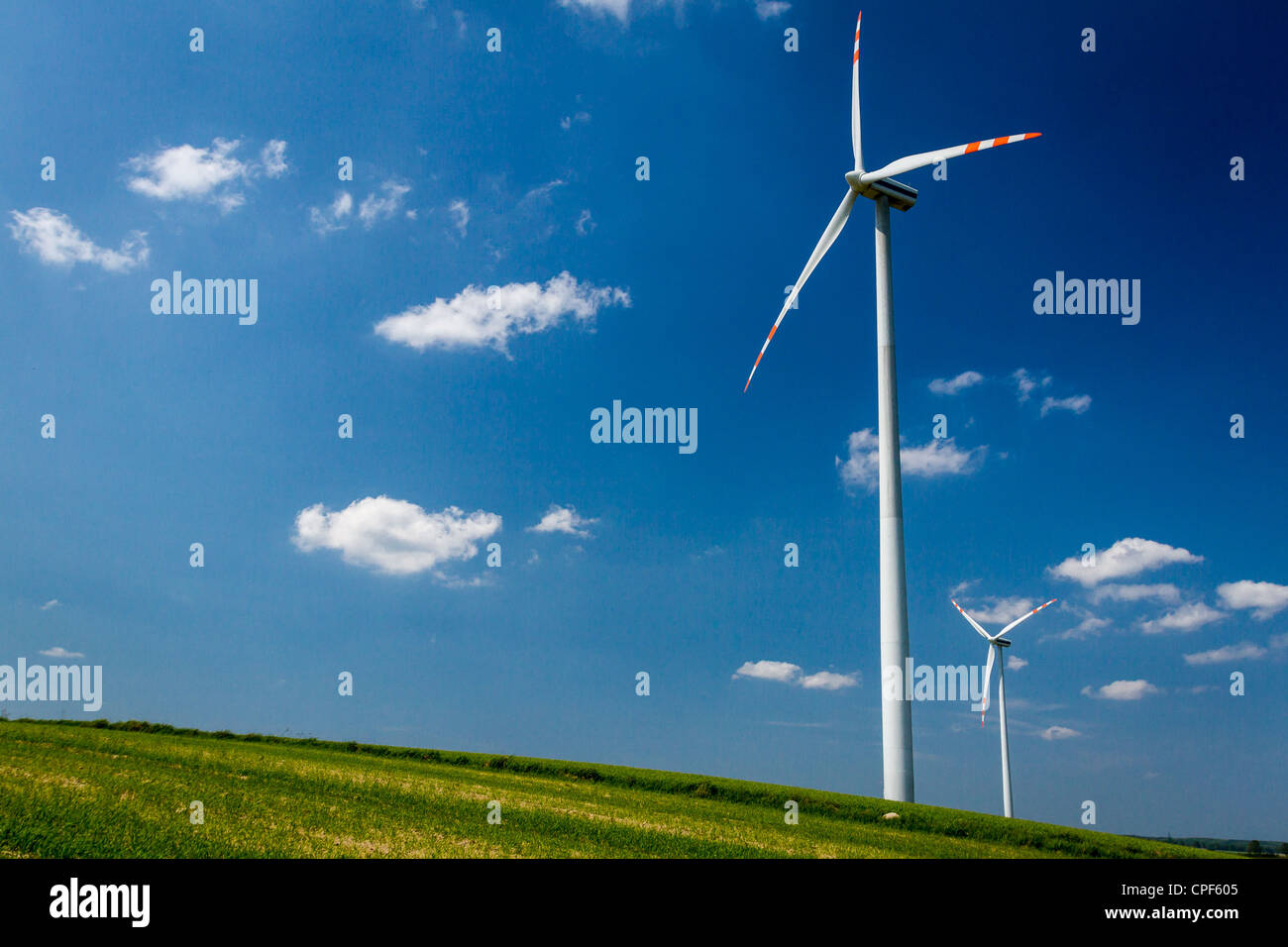 Alternative energy wind turbines on green field Stock Photo - Alamy