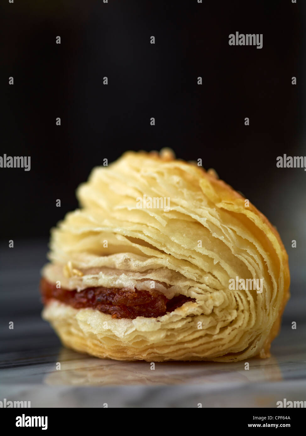 A BBQ Pork Puff or Char Siu Sou, a delicious Chinese Dim Sum pastry ...