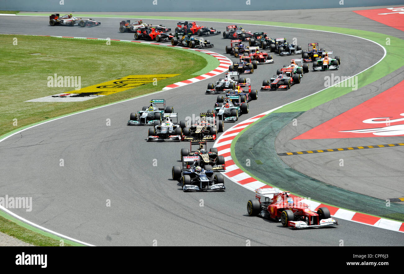 race cars speed through first corner after the start of the Formula 1 ...