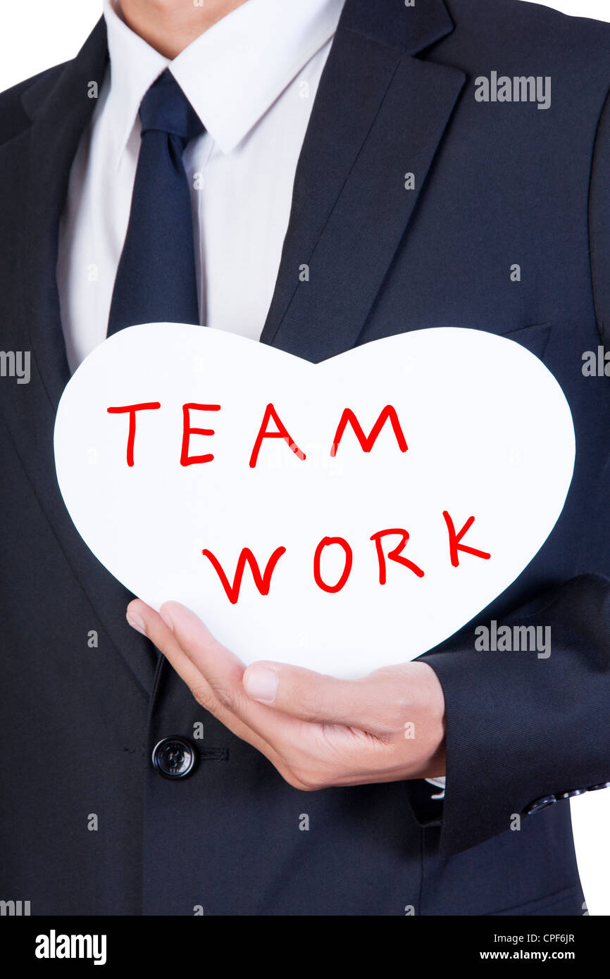 Businessman holding paper written teamwork in hand Stock Photo - Alamy